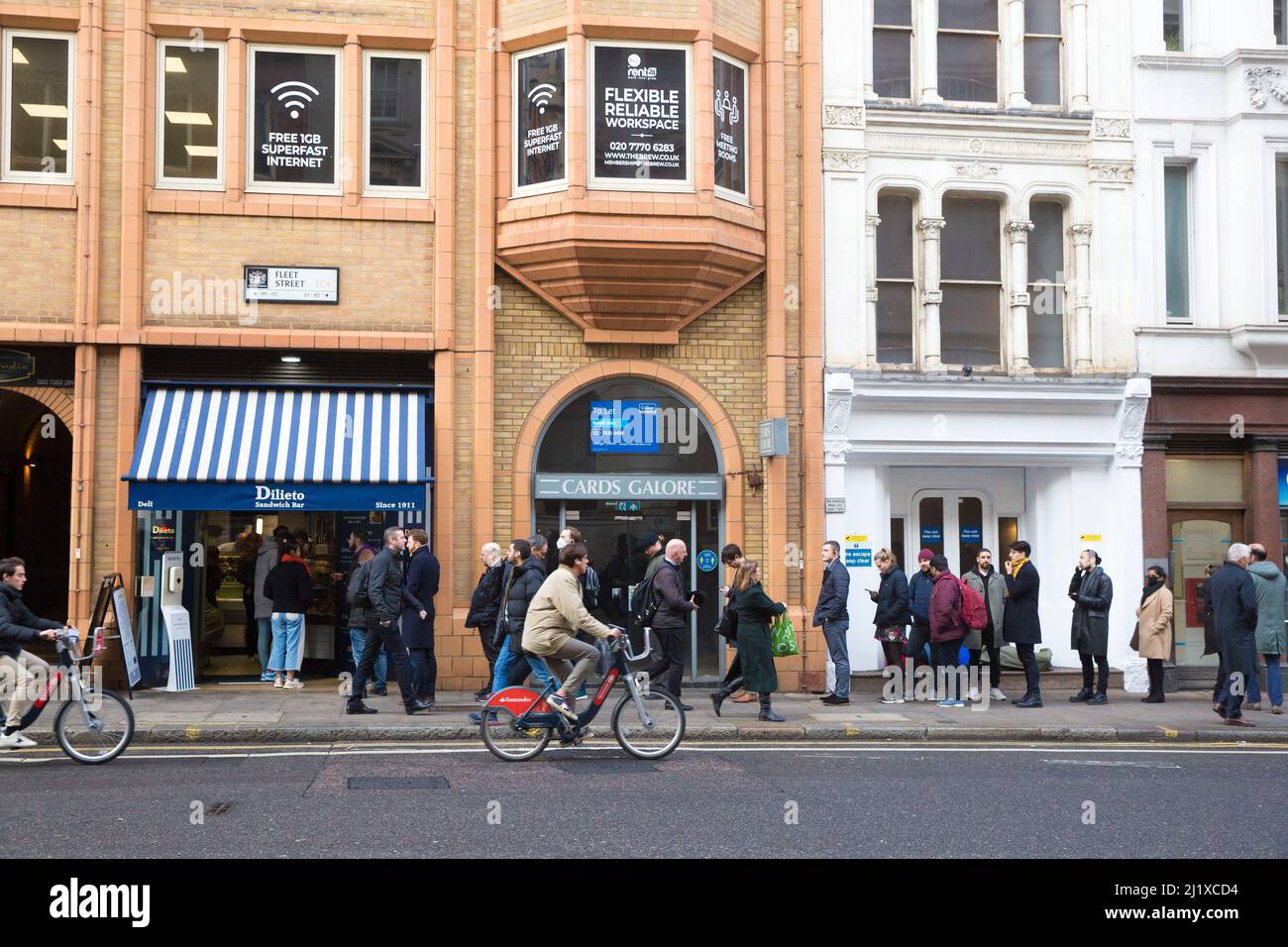 People queue outside a sandwich bar in London, at lunch hour, as work ...
