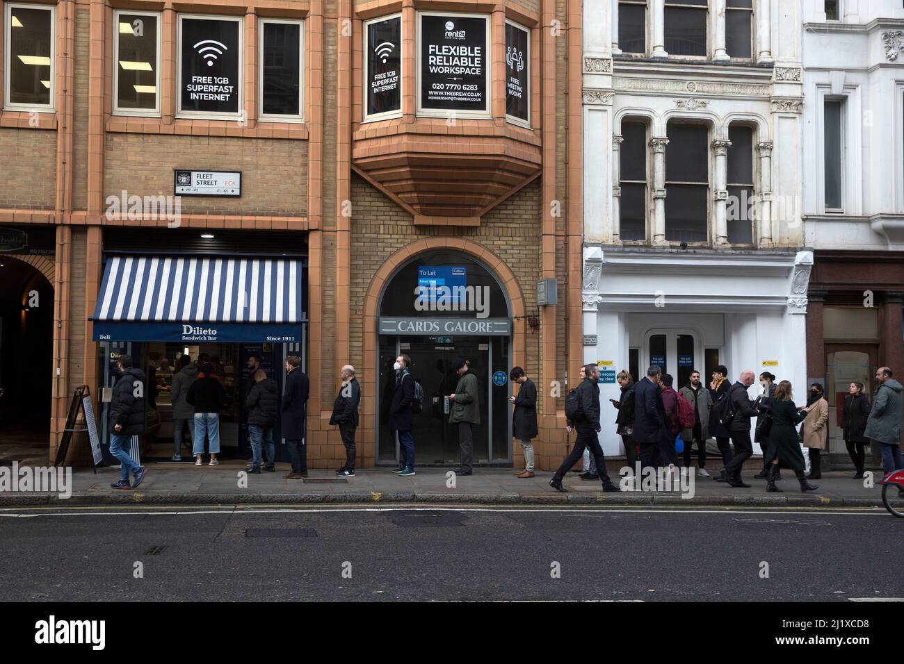 People queue outside a sandwich bar in London, at lunch hour, as work ...