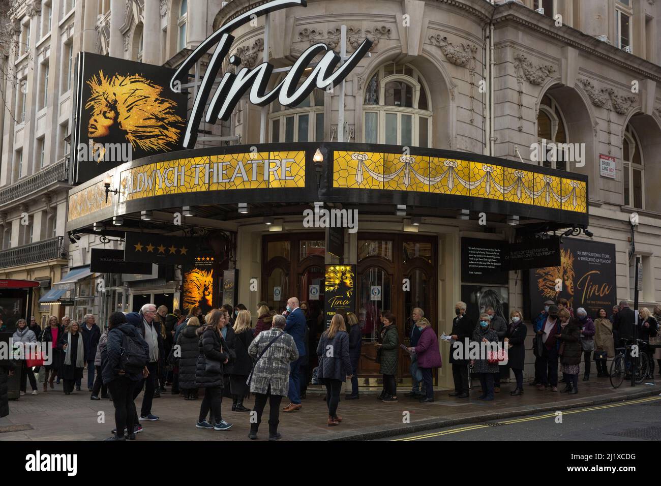 People queue outside the Aldwych Theatre in London after the relaxation ...