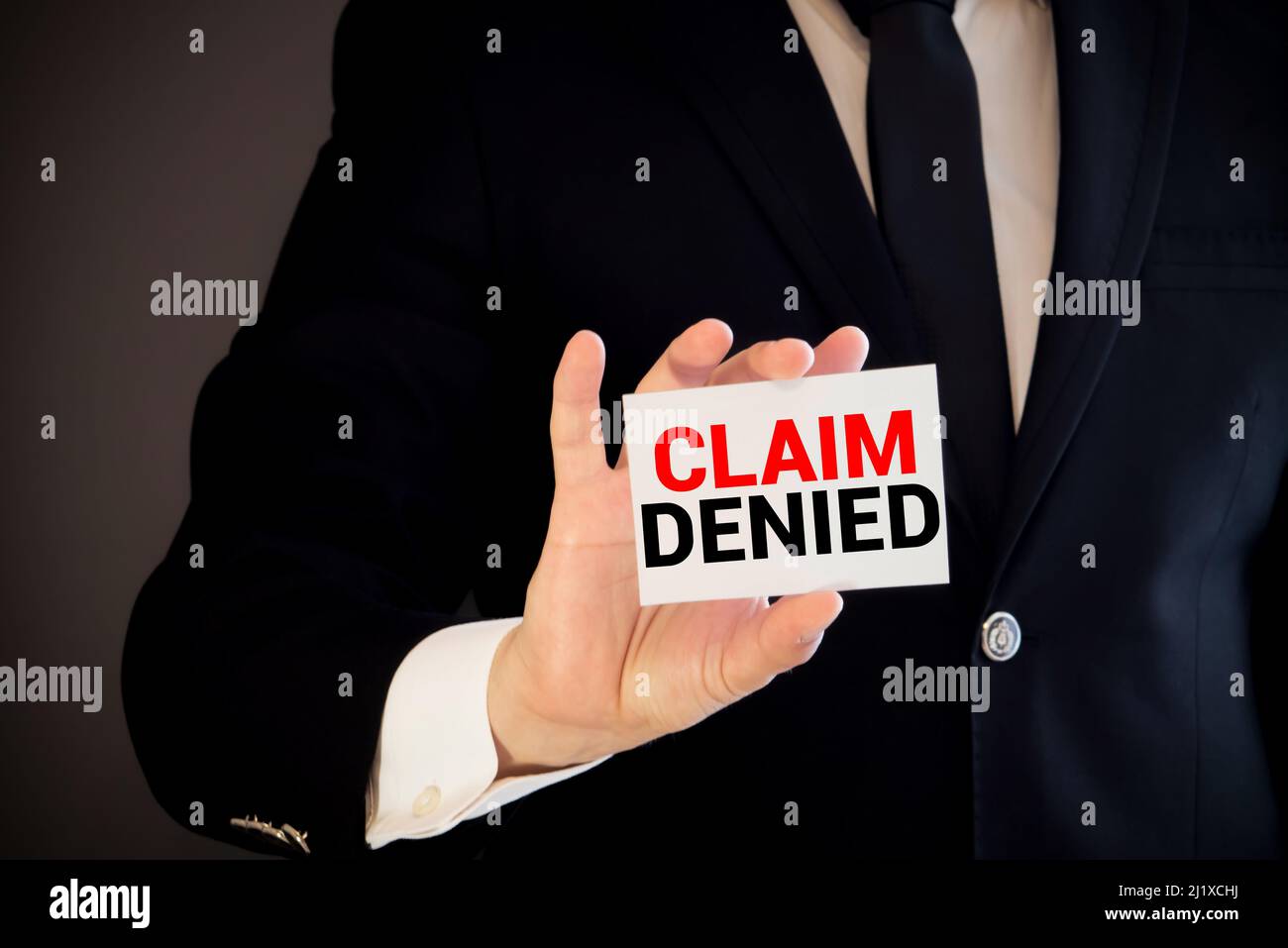 Businessman putting a card with text Claim Denied in the pocket Stock ... Businessman putting a card with text Claim Denied in the pocket Stock ...