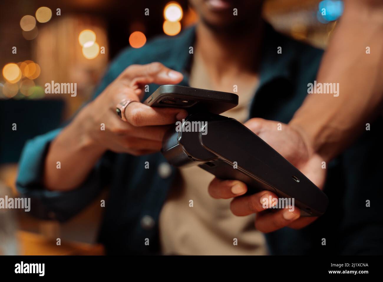 close up of customer paying with cellular device and card machine Stock ...