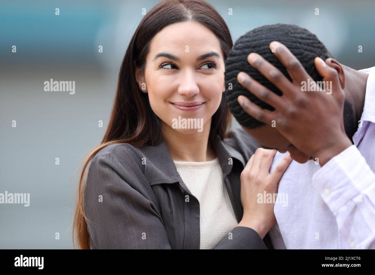 Happy false friend consoling a desperate man in the street Stock Photo ...