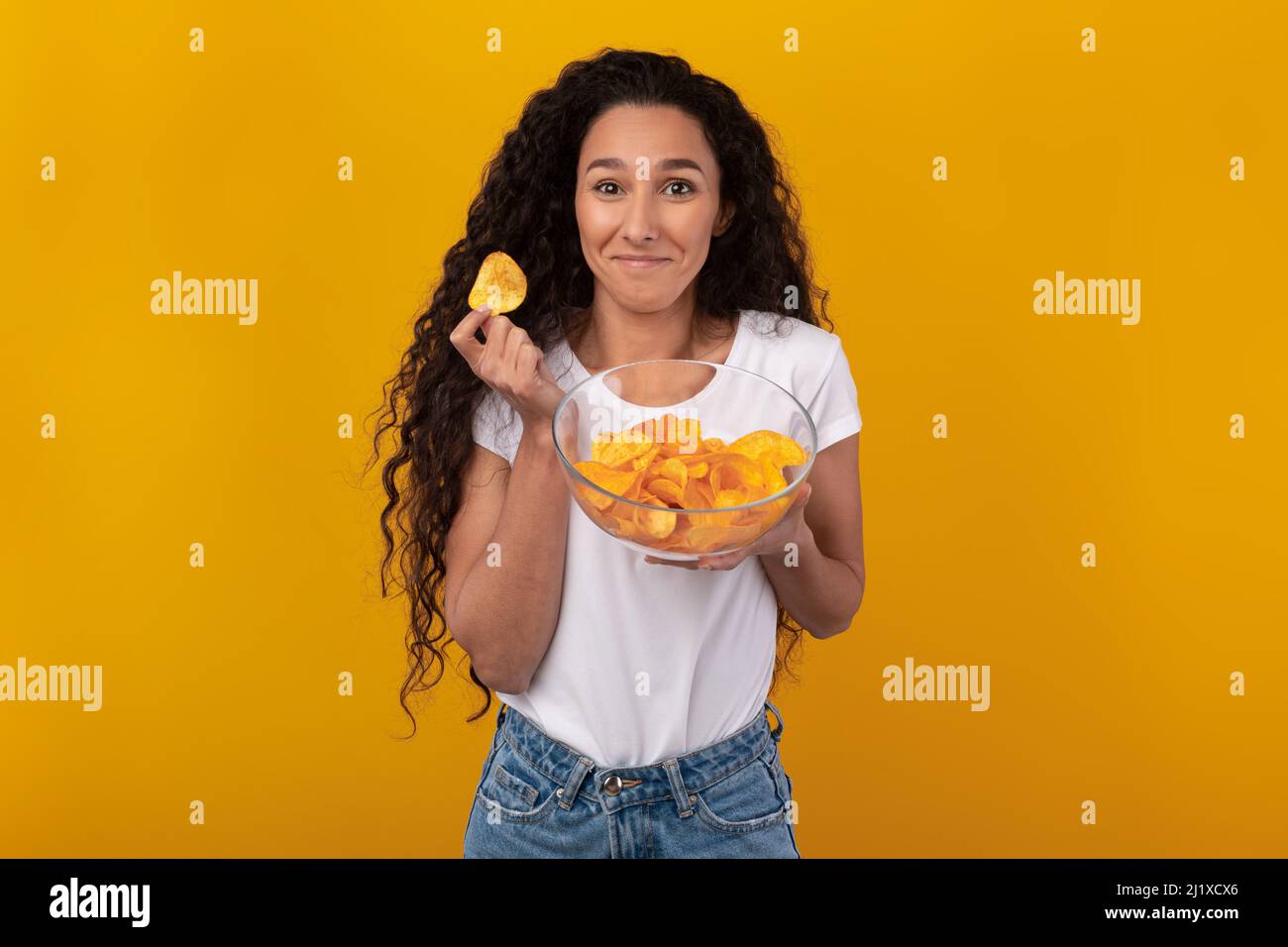 Fat person eating chips hi-res stock photography and images - Alamy