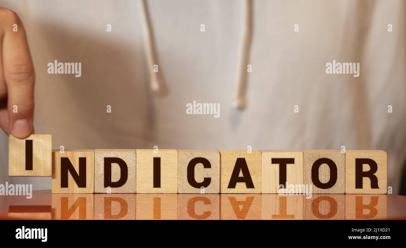 Indicate word on wooden blocks on cyan background. Financial indicator ...
