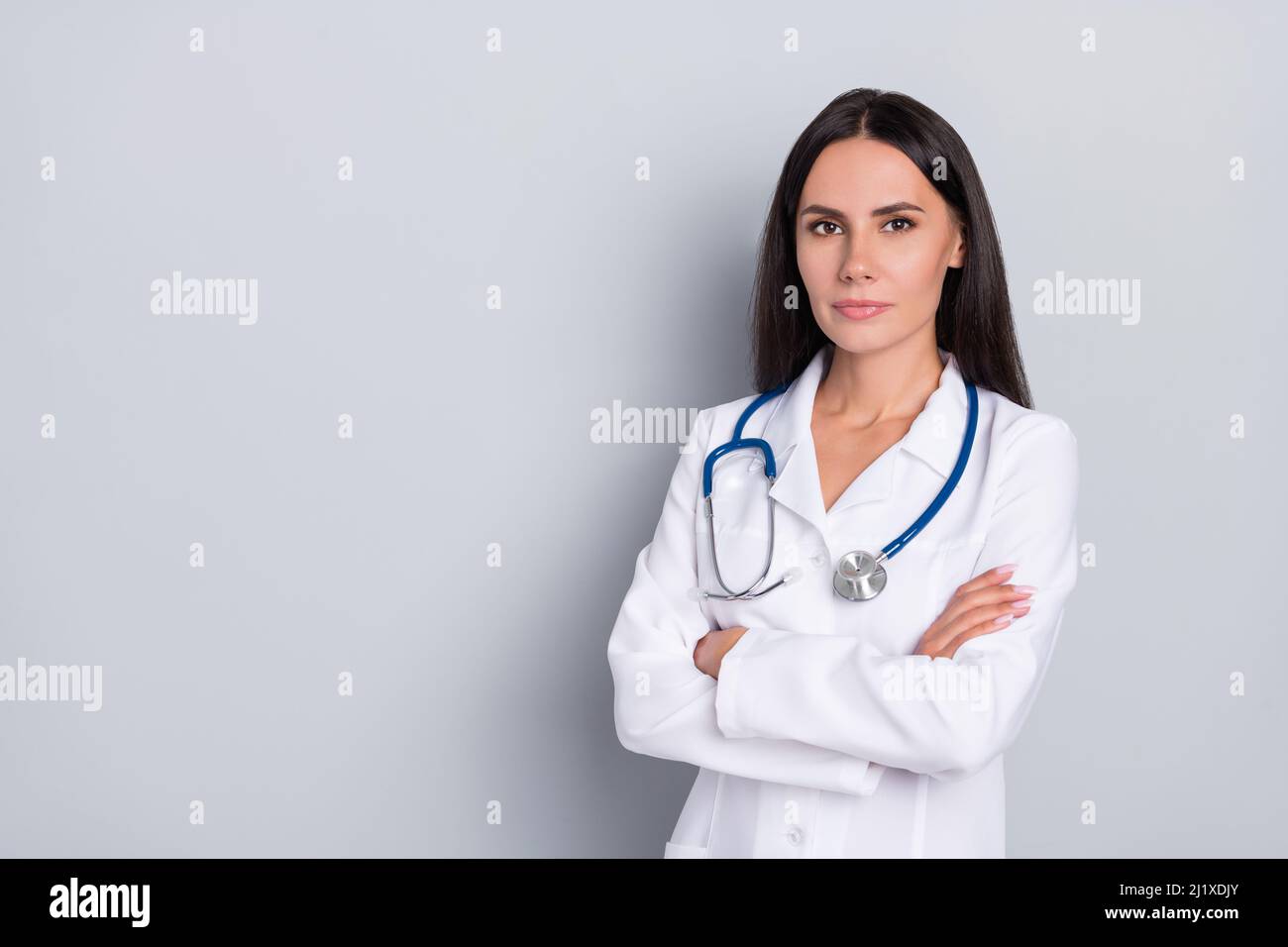 Photo of calm surgeon focused lady folded arms empty space banner ...