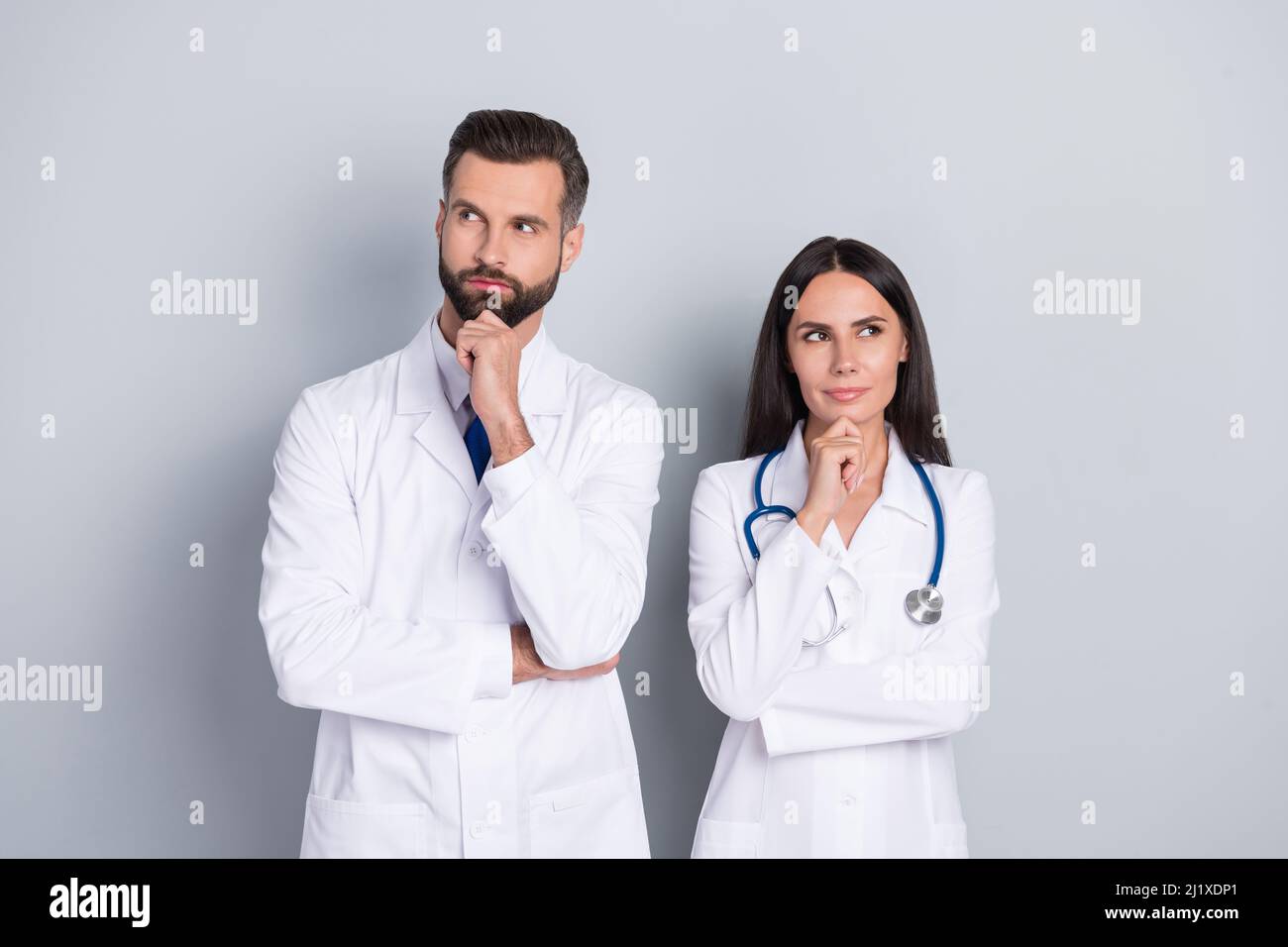 Photo of dreamy clever two docs dressed white coats looking empty space ...