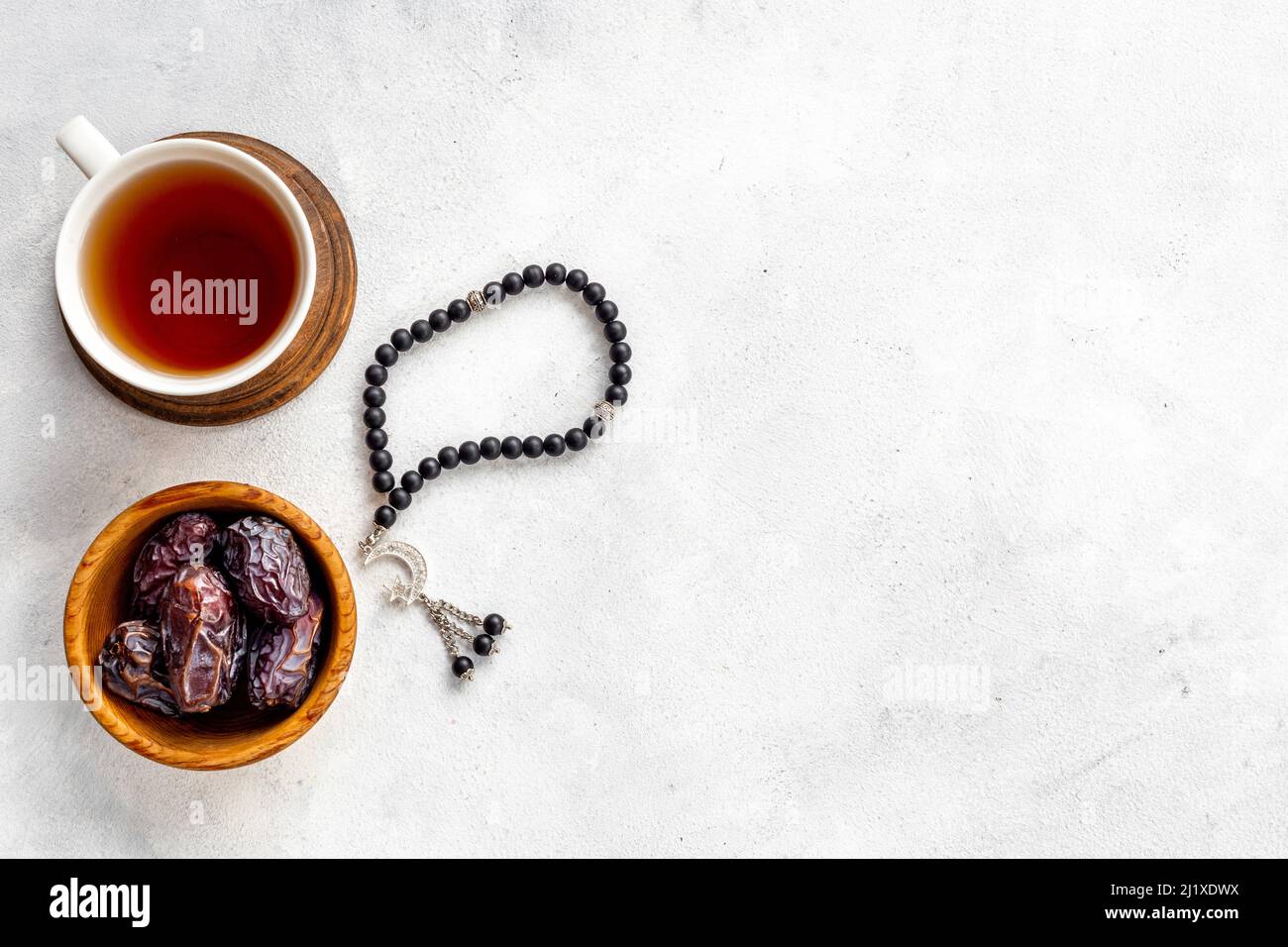 Turkish tea on Ramadan with islamic rosary and dates fruits in bowl ...