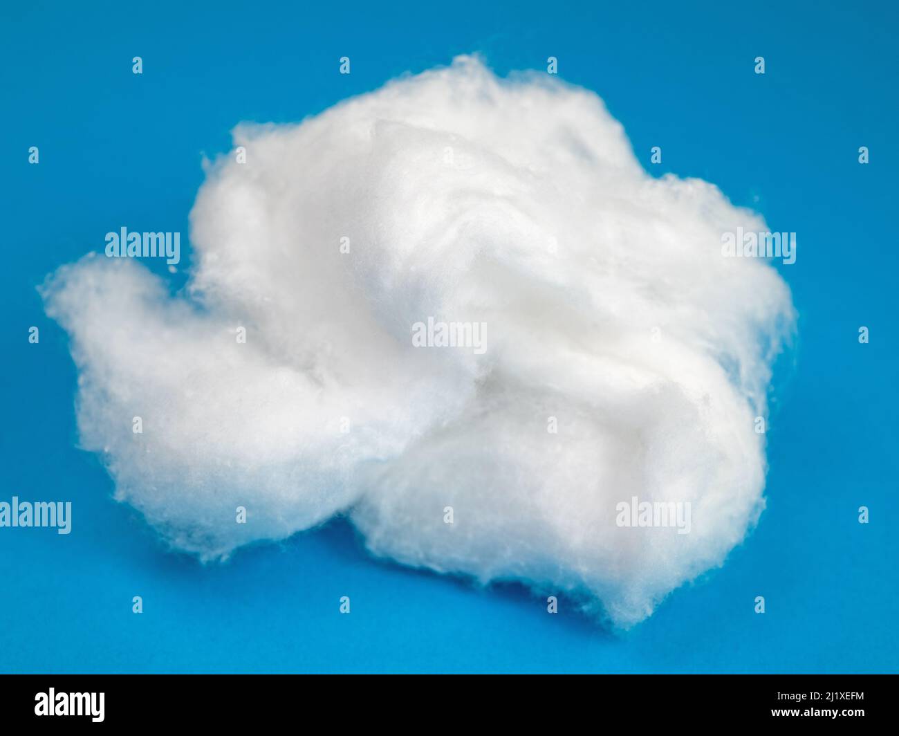 Cotton wadding against a blue background Stock Photo - Alamy