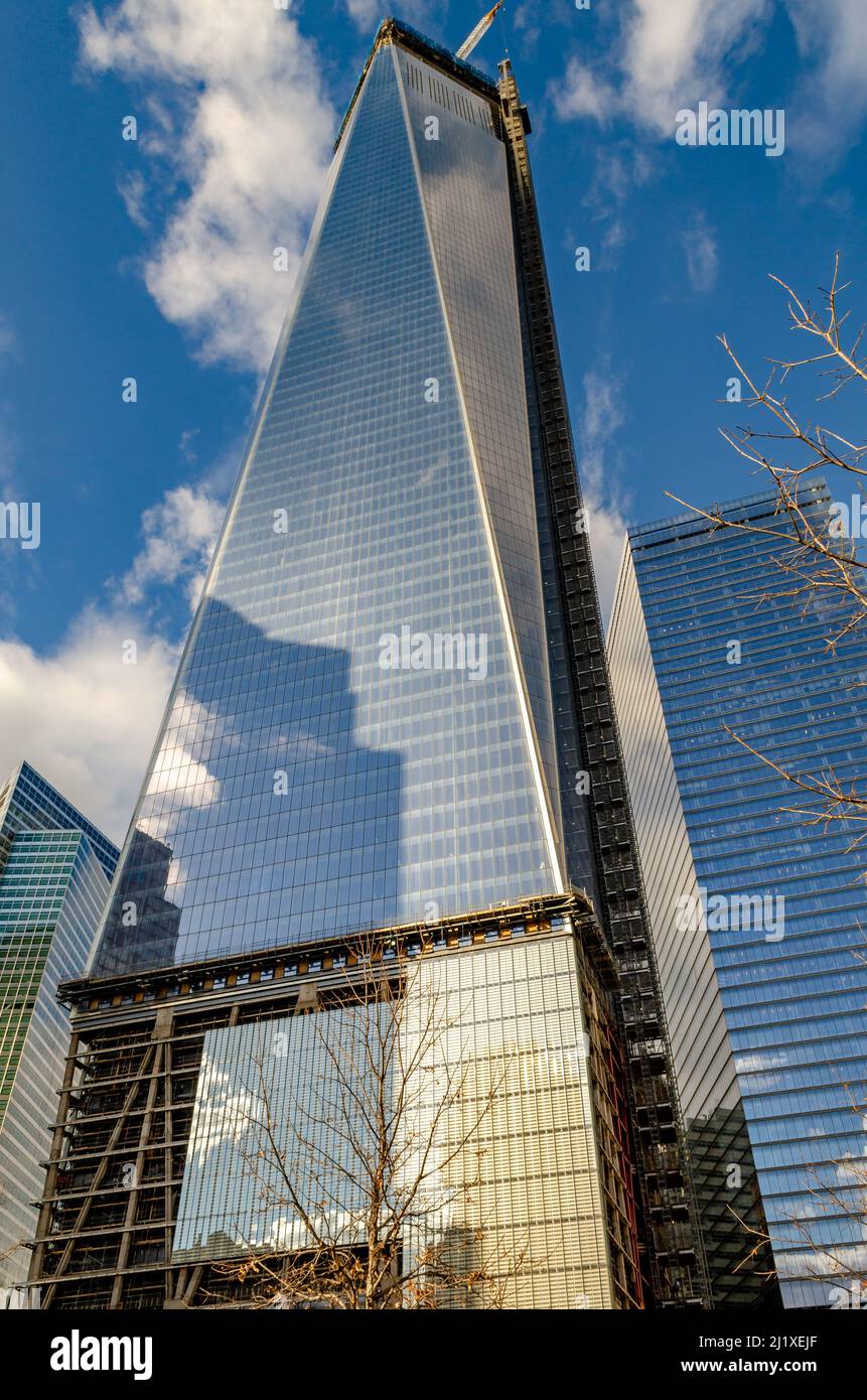 One World Trade Center construction area with clouds reflection in the ...
