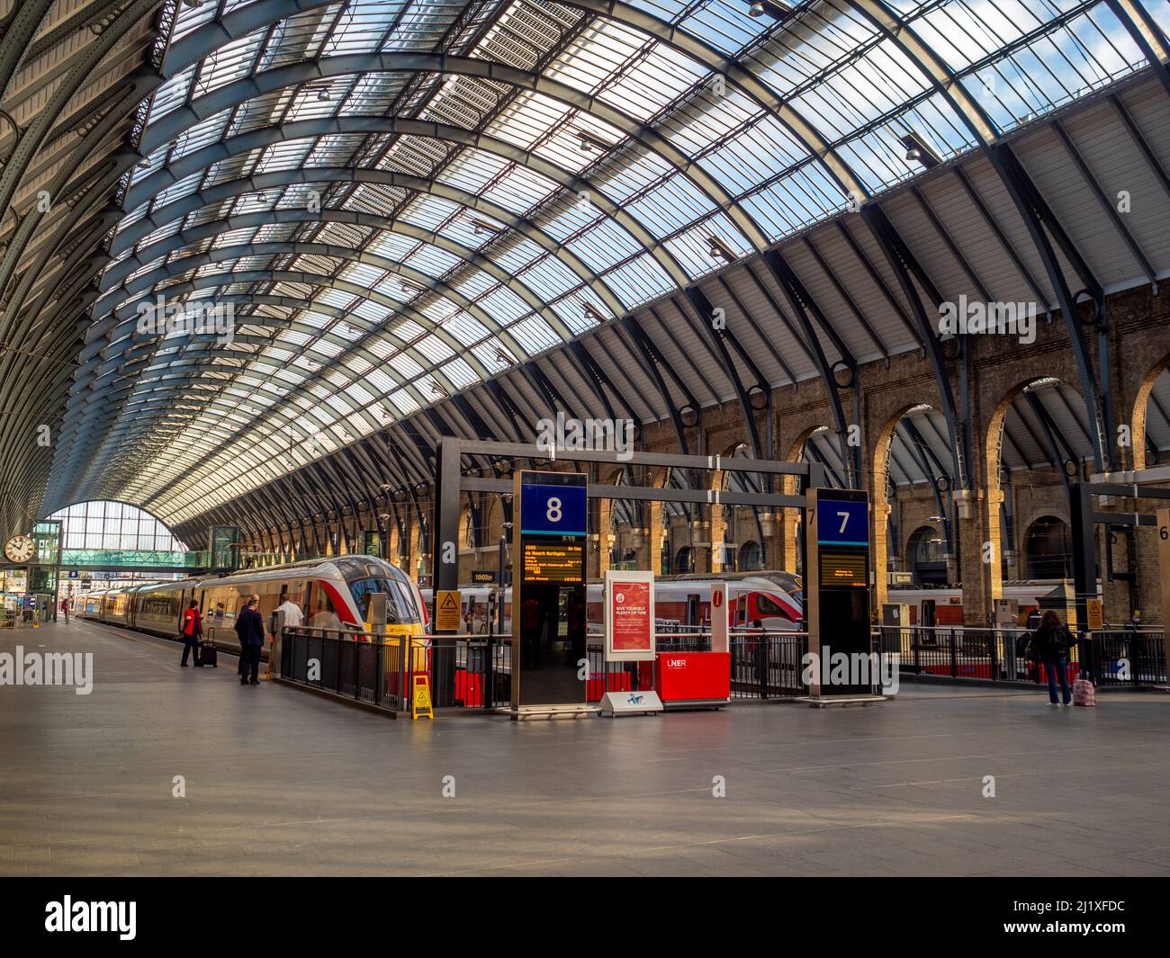 Platforms 7 and 8 of London King's Cross station on a sunny day. London ...