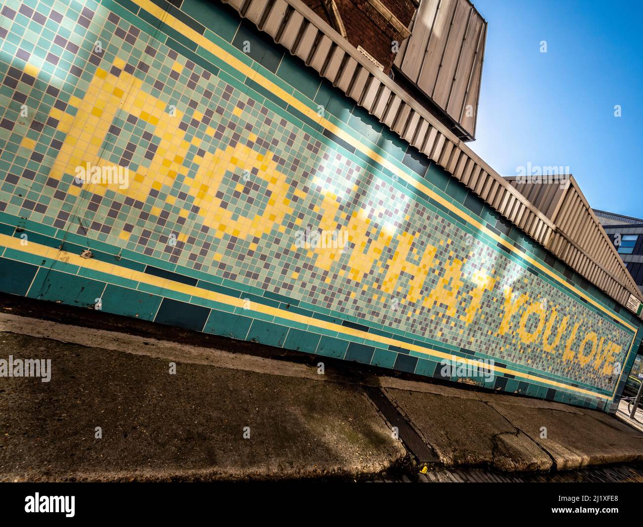 Inspirational tiled message "Do what you love" on the façade of the ...
