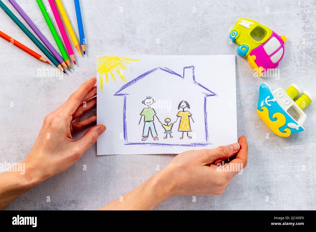 Drawing of parents and child at home. Adoption concept Stock Photo - Alamy