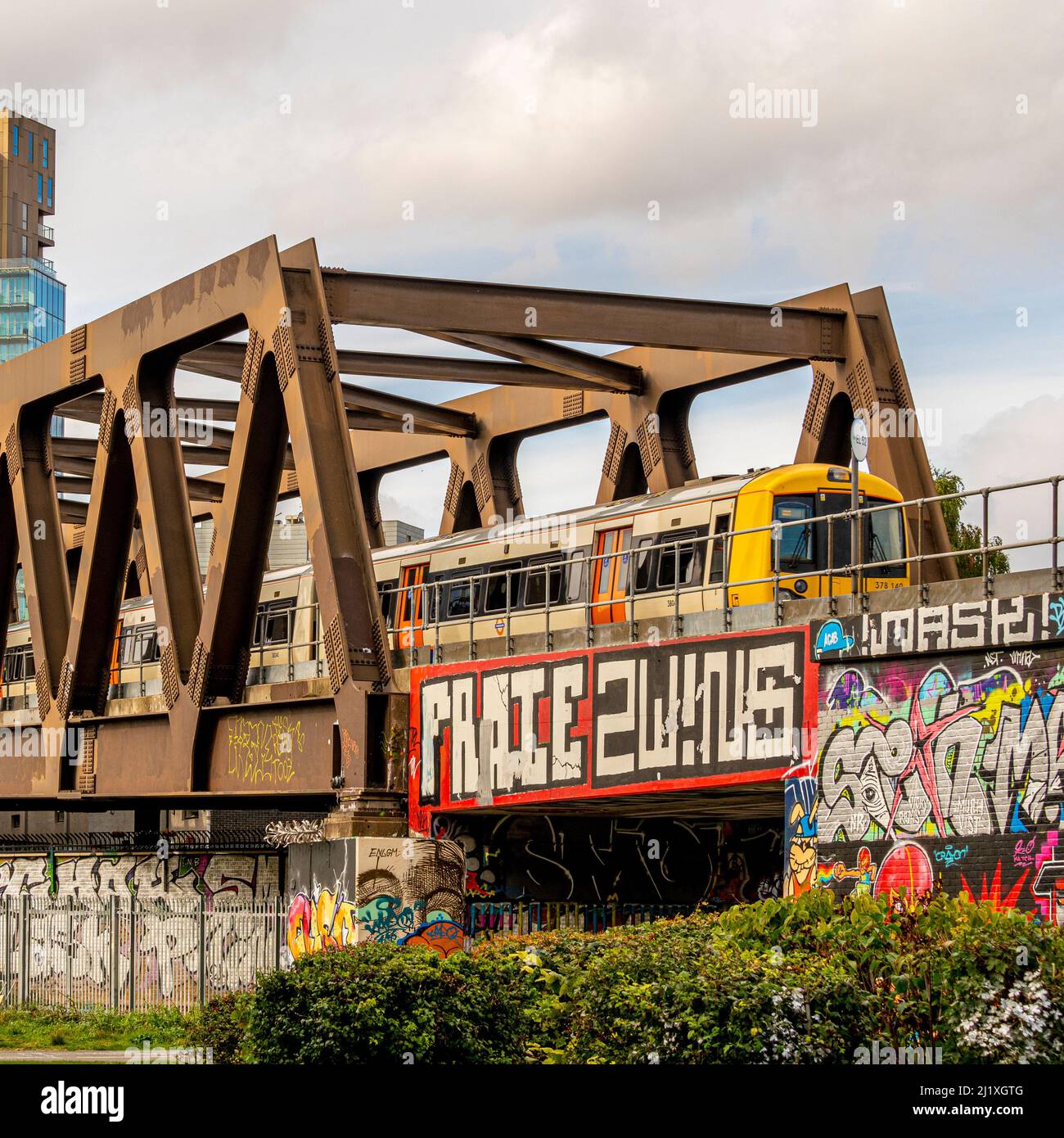 Railway bridge with graffiti seen from Station Park in the Spitalfields ...