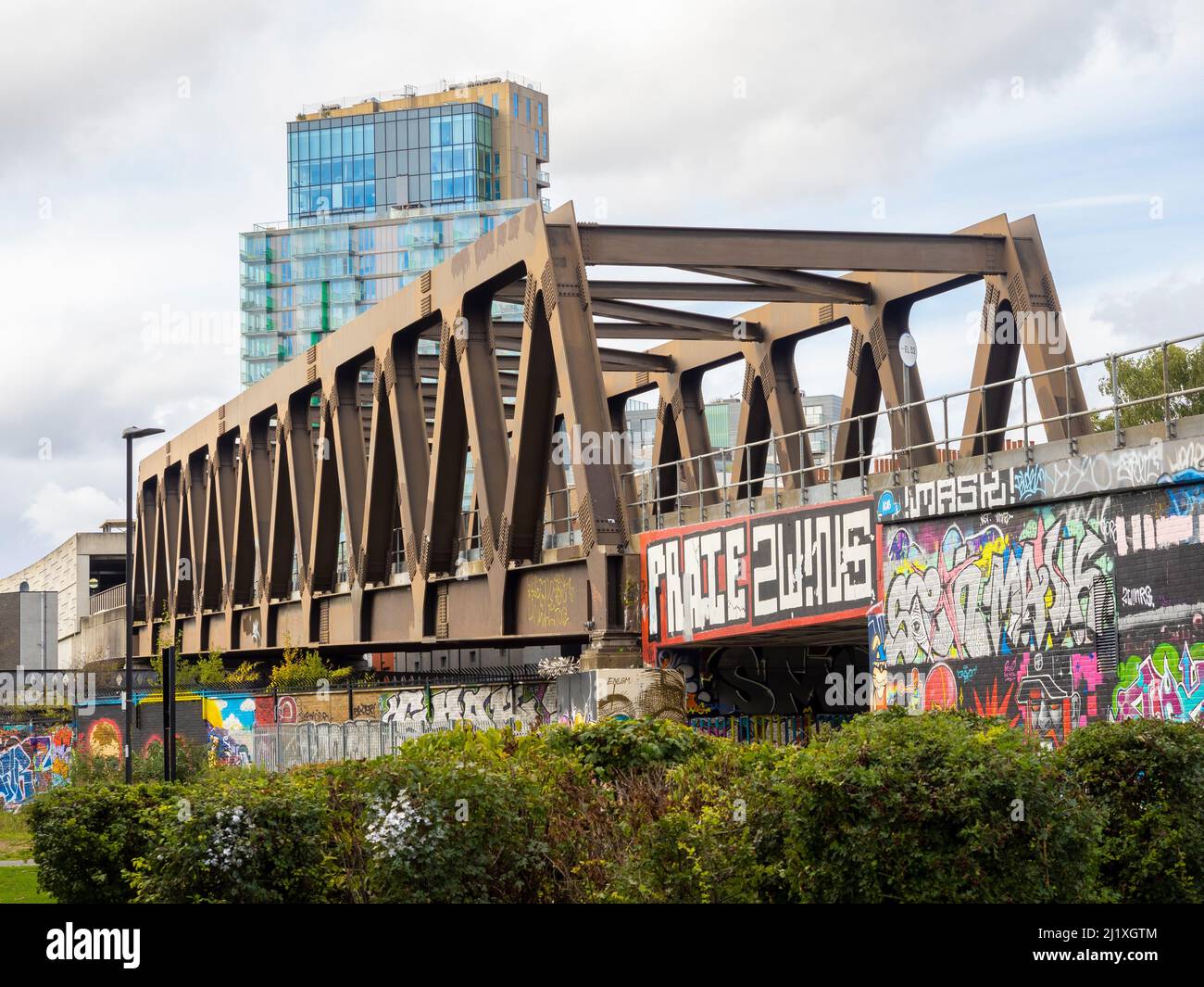 Railway bridge with graffiti seen from Station Park in the Spitalfields ...