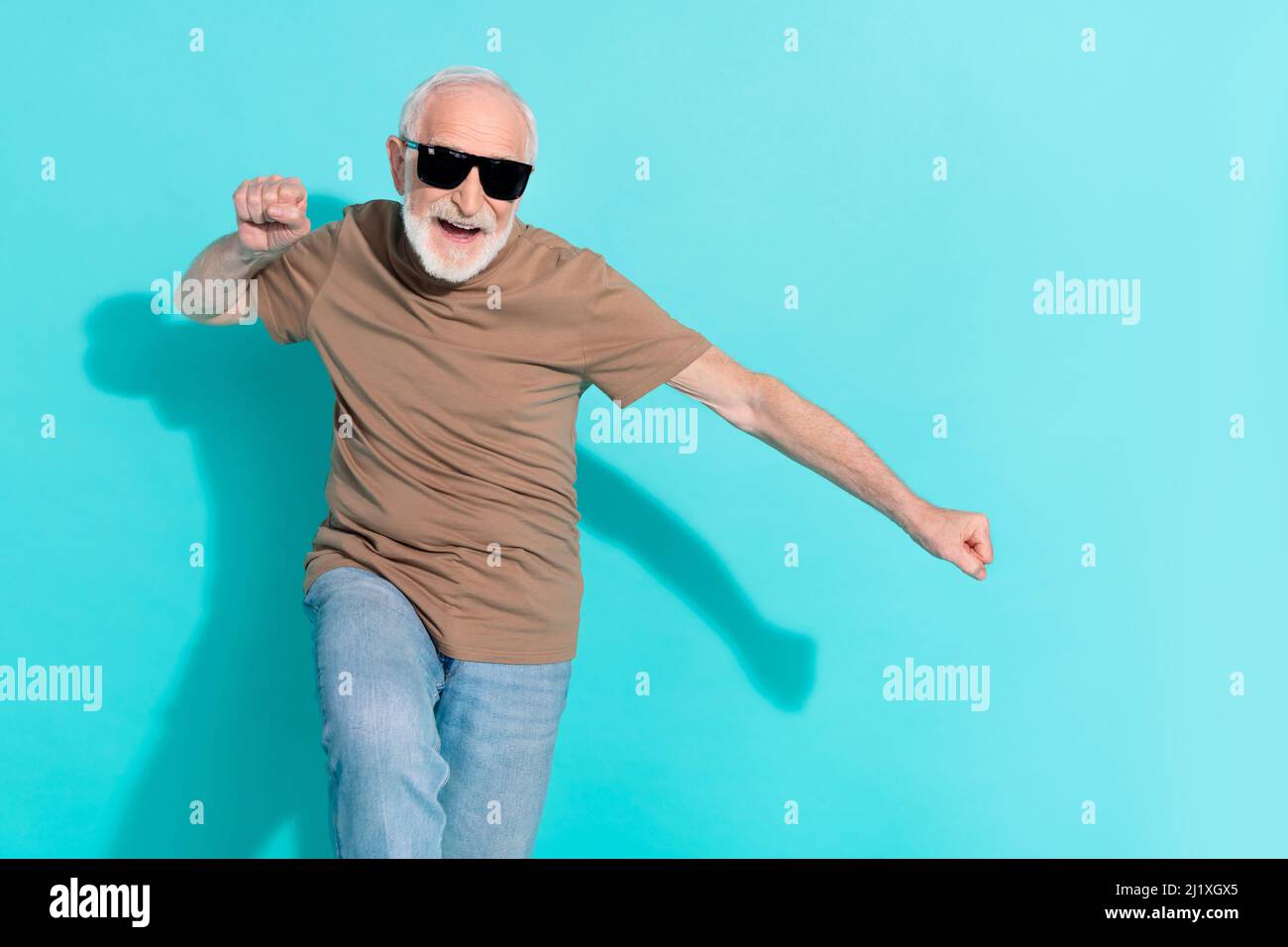 Portrait of attractive cheerful grey-haired man dancing having fun rest ...