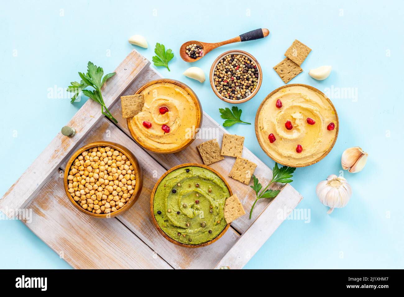 Flatlay of different types of colorful hummus in bowls. Vegan food ...