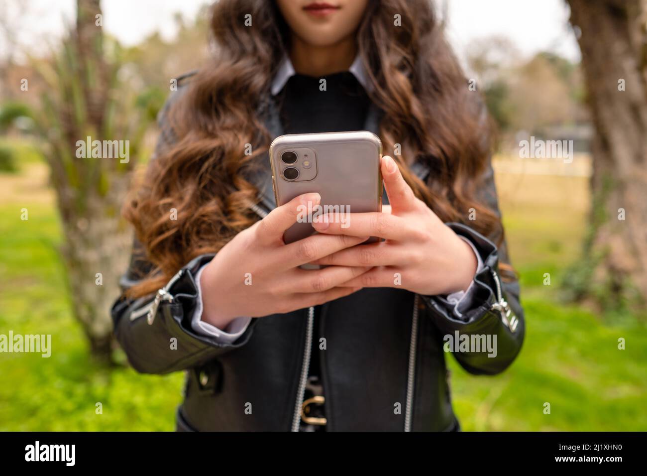 Typing text message, close up of a young woman's hand typing text ...