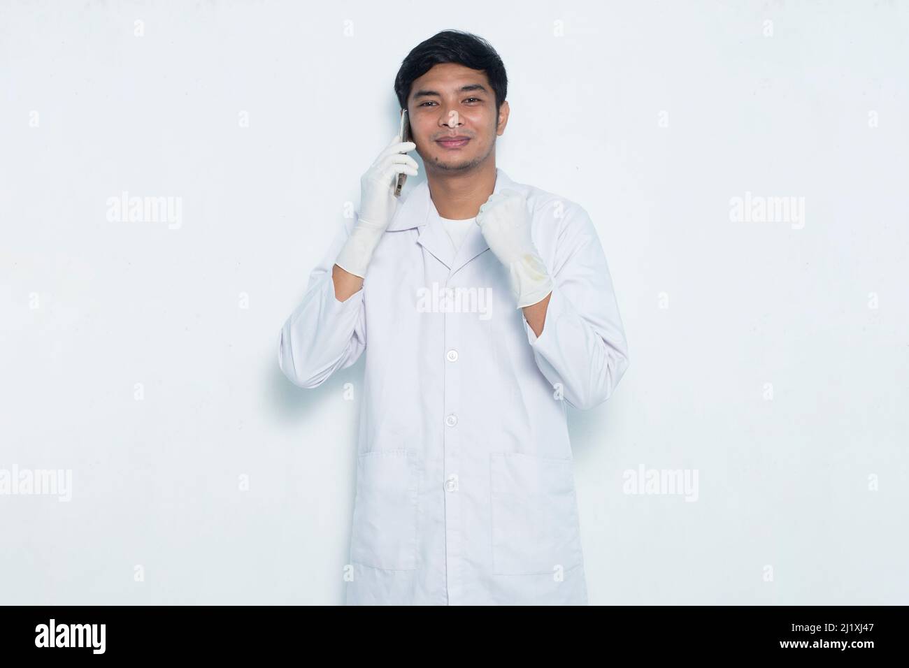 portrait of asian medical doctor using mobile phone isolated on white ...