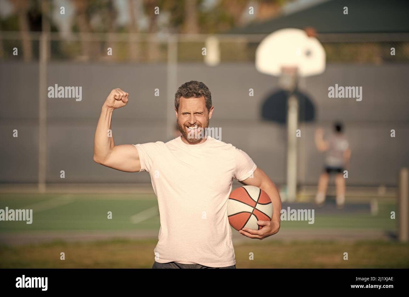 summer activity. happy muscular man with basketball ball. sport trainer ...