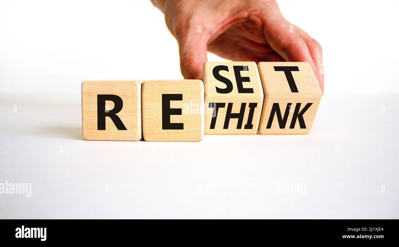 Rethink and reset symbol. Businessman turns wooden cubes and changes ...