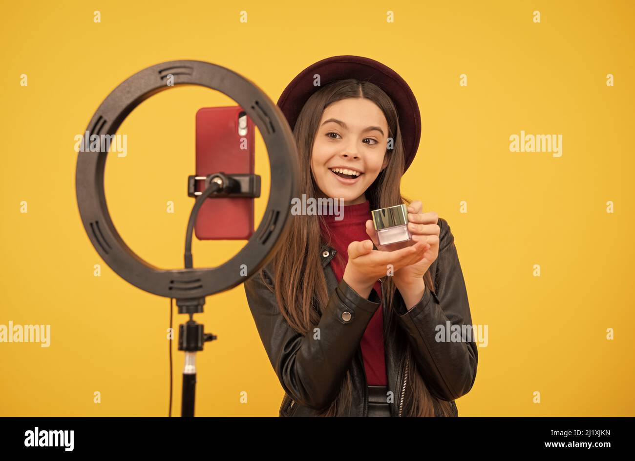 happy teen girl blogger use selfie led lamp and smartphone on tripod ...