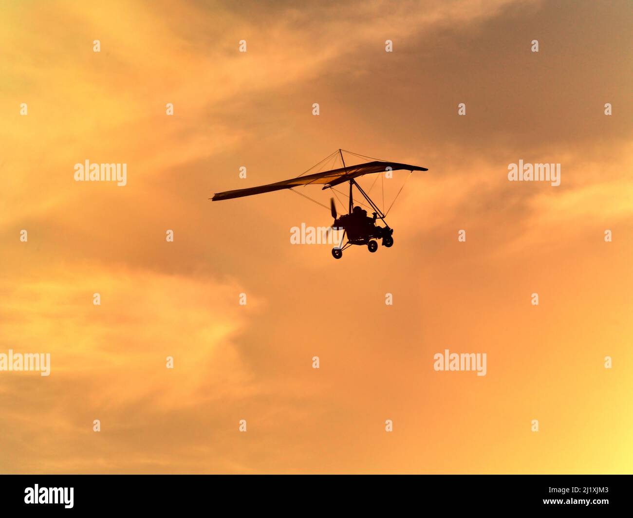 view of powered kite flying in a sunset Stock Photo - Alamy
