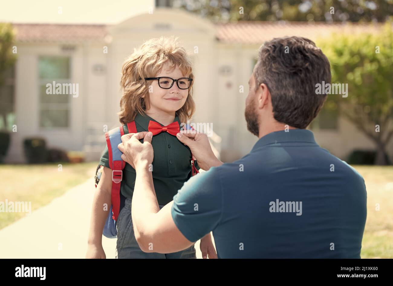 father and son come back from school. happy family value. childhood and ...