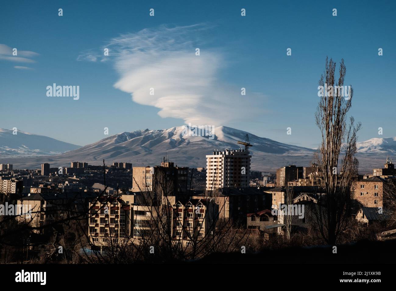 An urban scenery of residential buildings surrounded by mountains with ...