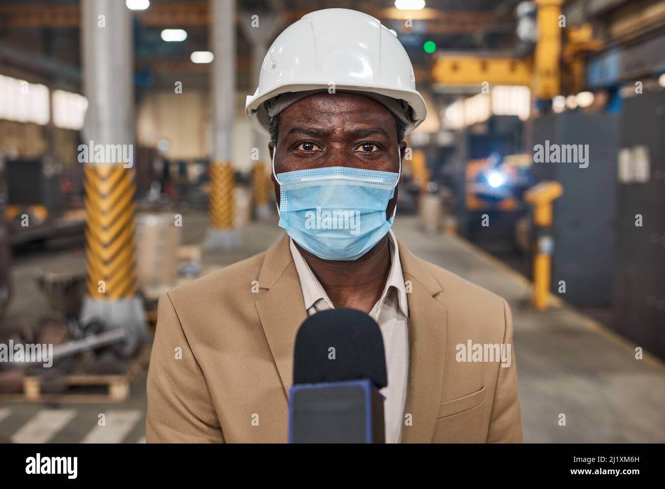 Man hardhat microphone hi-res stock photography and images - Alamy