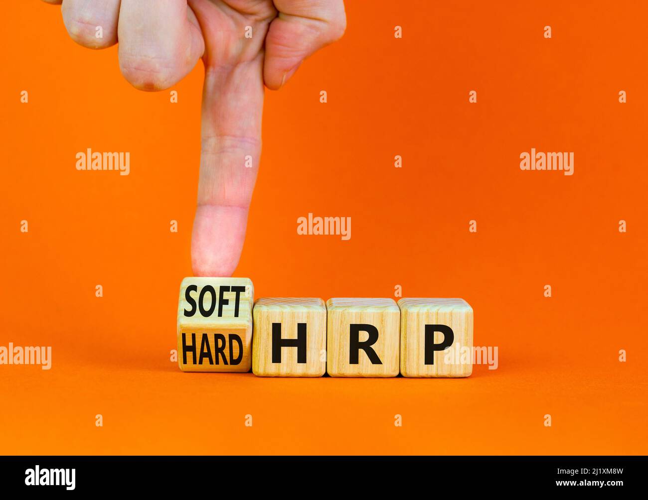 HRP, human resource planning symbol. Businessman turns a wooden cube ...