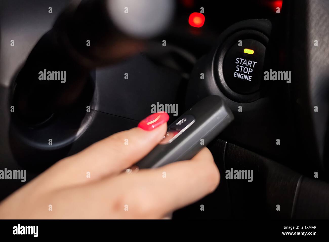 The car owner holds in his hand a remote control device for keyless ...