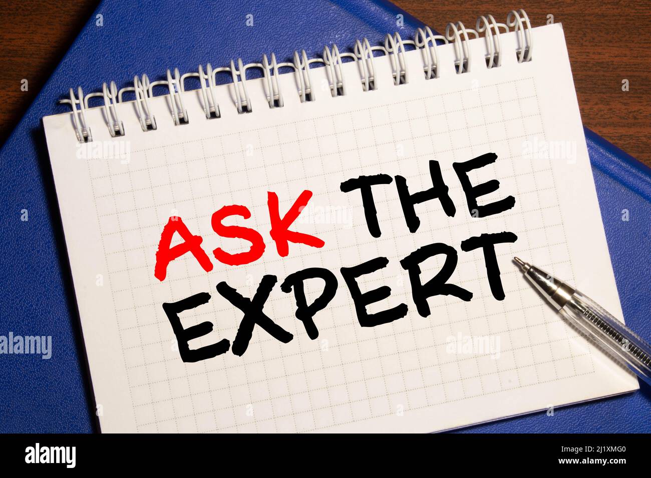 Ask an expert text is signed by marker on white paper Stock Photo - Alamy