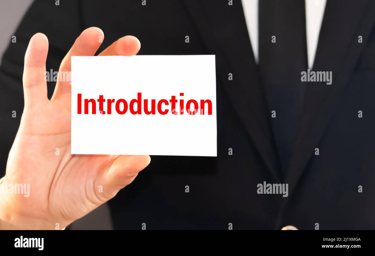 Introduction. Text on a sheet of paper. On old wooden table smartphone ...