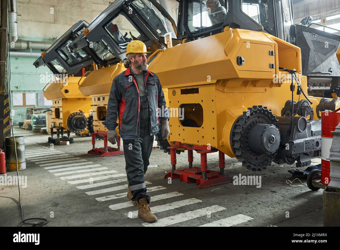 Professional foreman in uniform walking along the corridor with ...