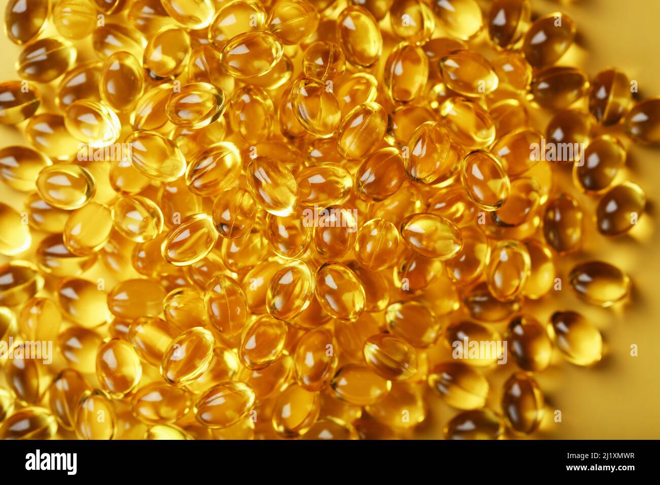 Golden capsules of Vitamin Omega 3 Fish Oil close-up in full screen ...