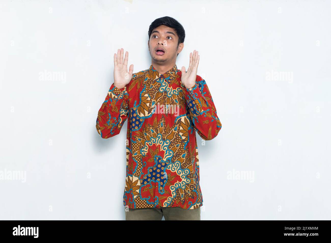 asian man wearing batik feeling surprise shocked isolated on white ...