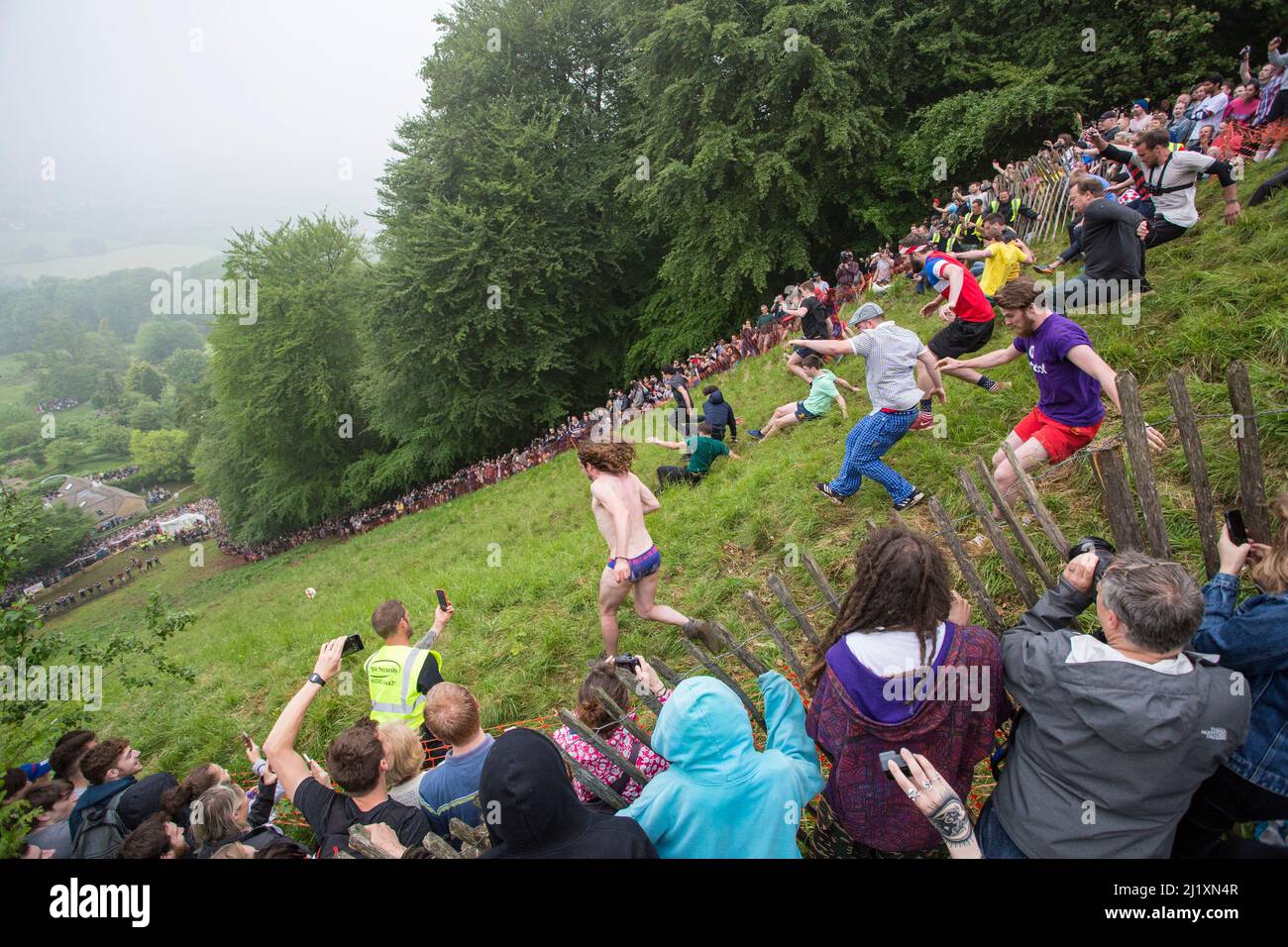 Gloucester, UK. The annual cheese rolling race held at Coopers Hill ...