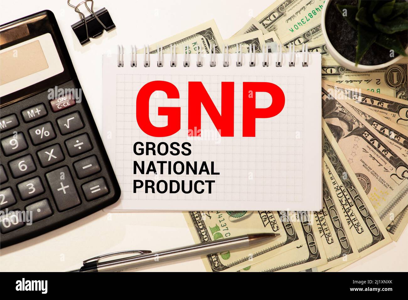 GNP Gross National Product acronym written in notebook on wooden ...