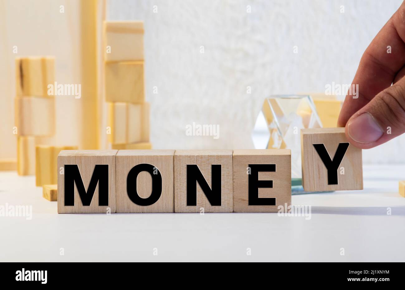 Wooden blocks with the lettering Money on top of ascending bar graphs ...