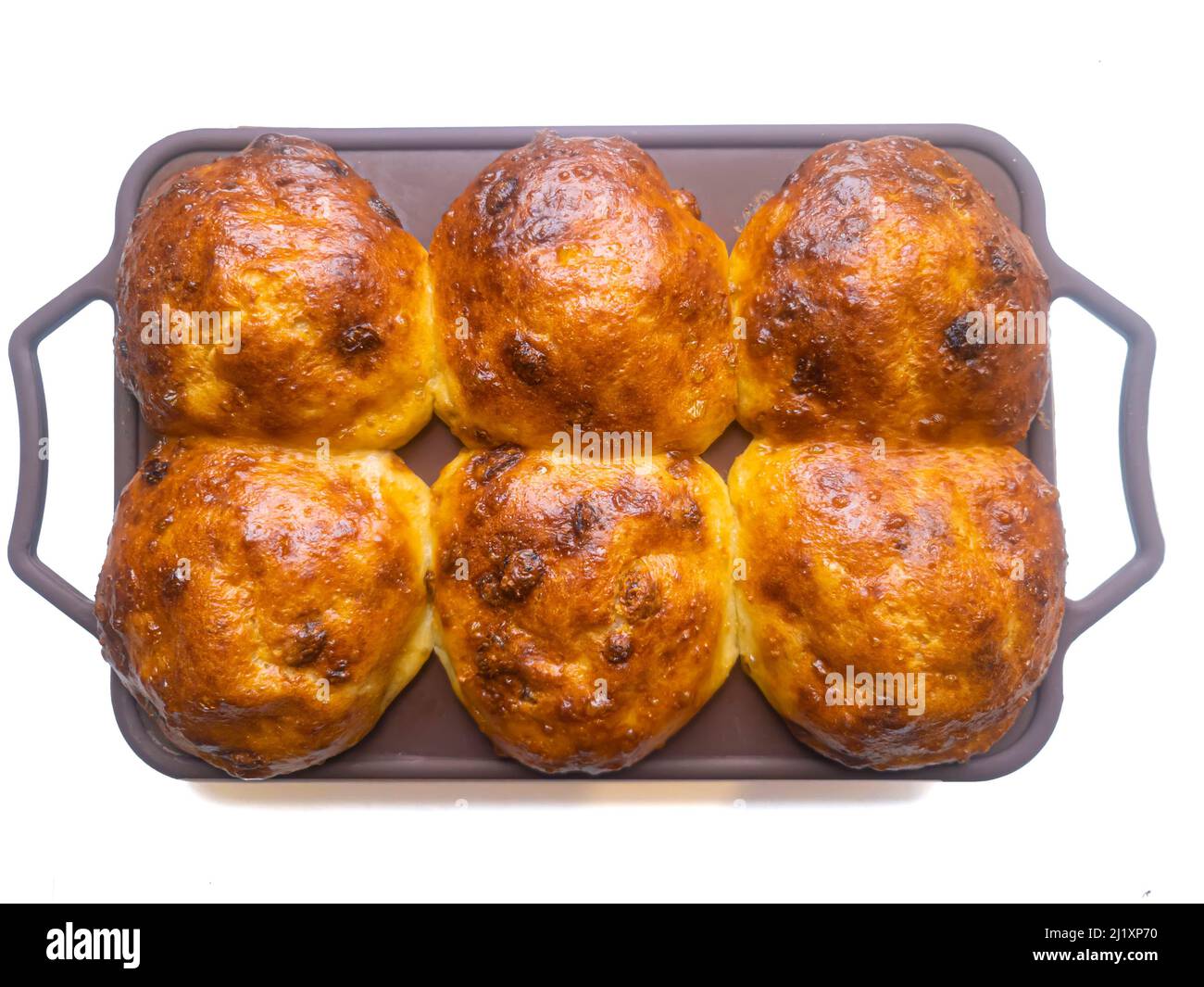 Lush buns with a golden crust in a silicone mold on top Stock Photo - Alamy