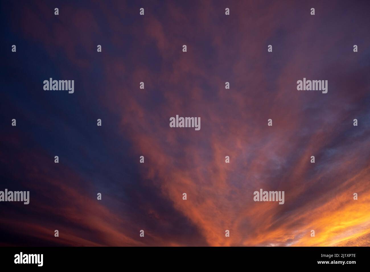 Colourful sunset with clouds underlit by the setting sun Stock Photo ...