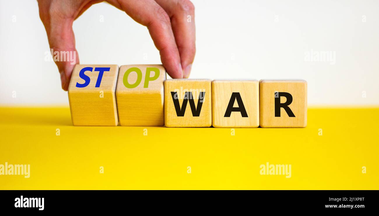 Stop war symbol. Businessman turns cubes and changes concept words War ...