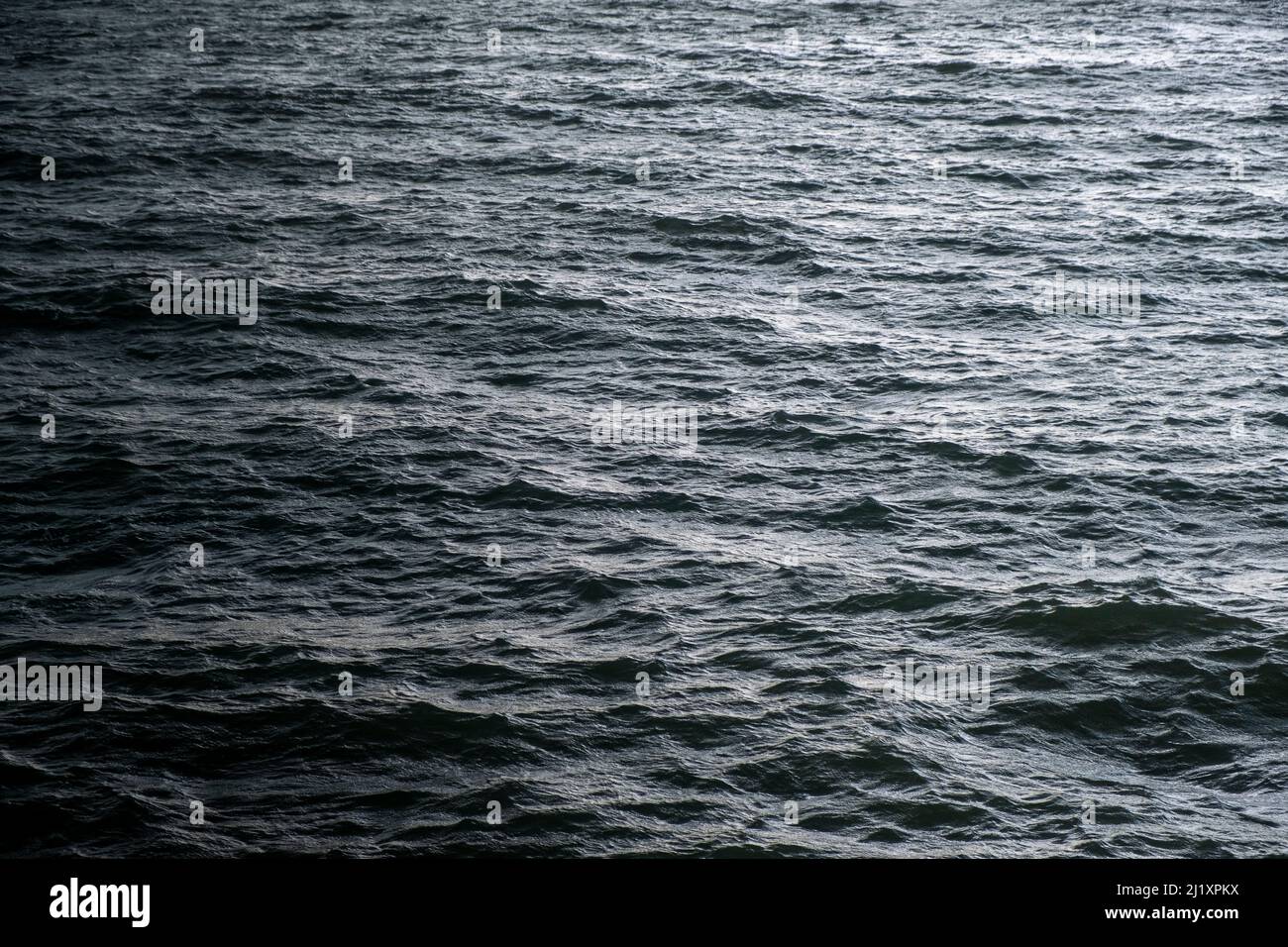 Sunlight relecting off the sea with bright refelected highlights on the ...