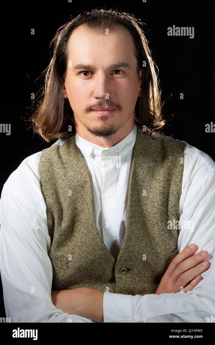 Portrait of a middle-aged man with long hair and mustache. Intelligent ...