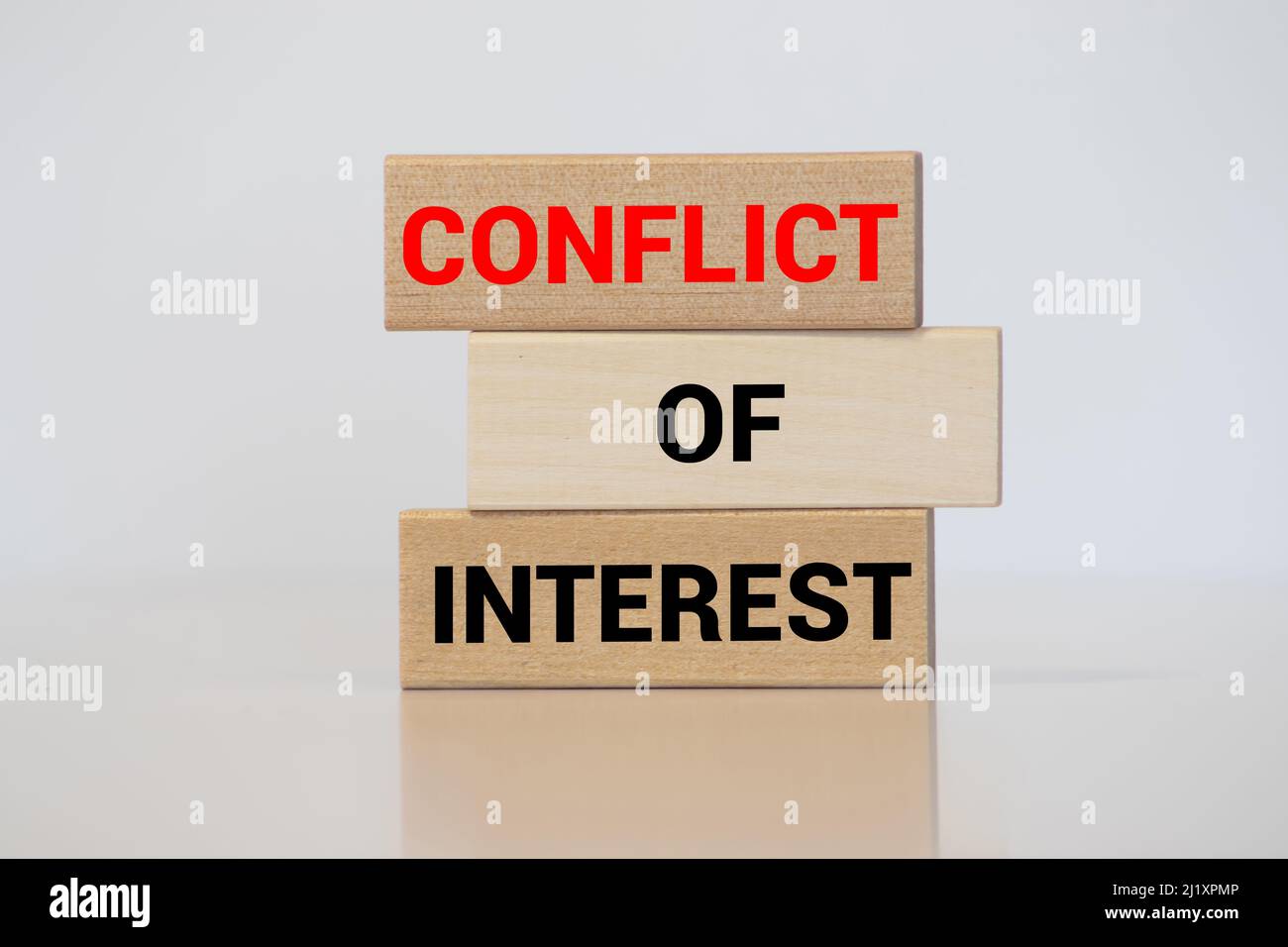 Male hand placing a block with word 'conflict' on top of a blocks tower ...