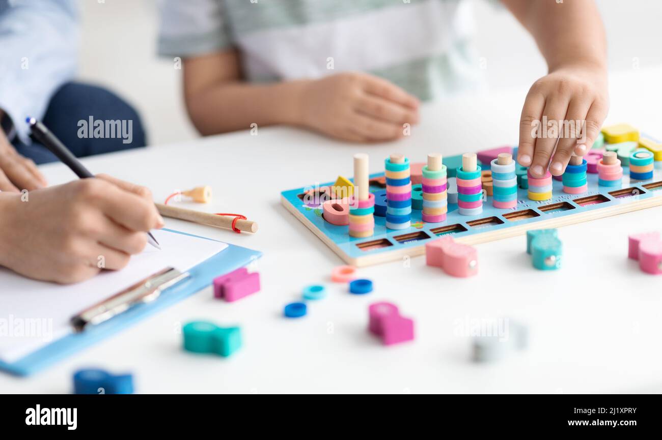 Modern organic toys for kids. Unrecognizable little boy playing ...