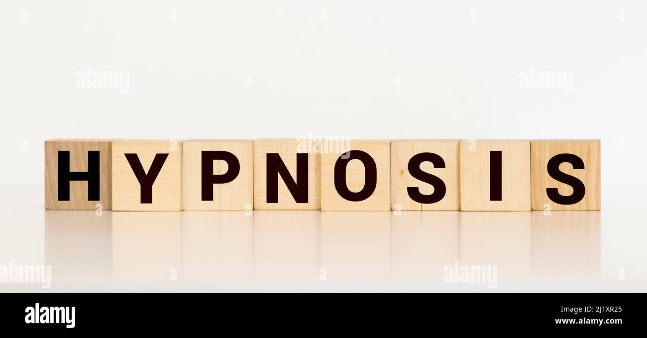 Hypnosis word written on wood block, concept Stock Photo - Alamy