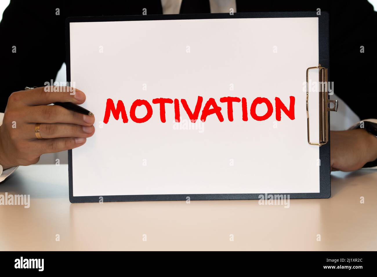 man holds the word motivation, business concept Stock Photo - Alamy