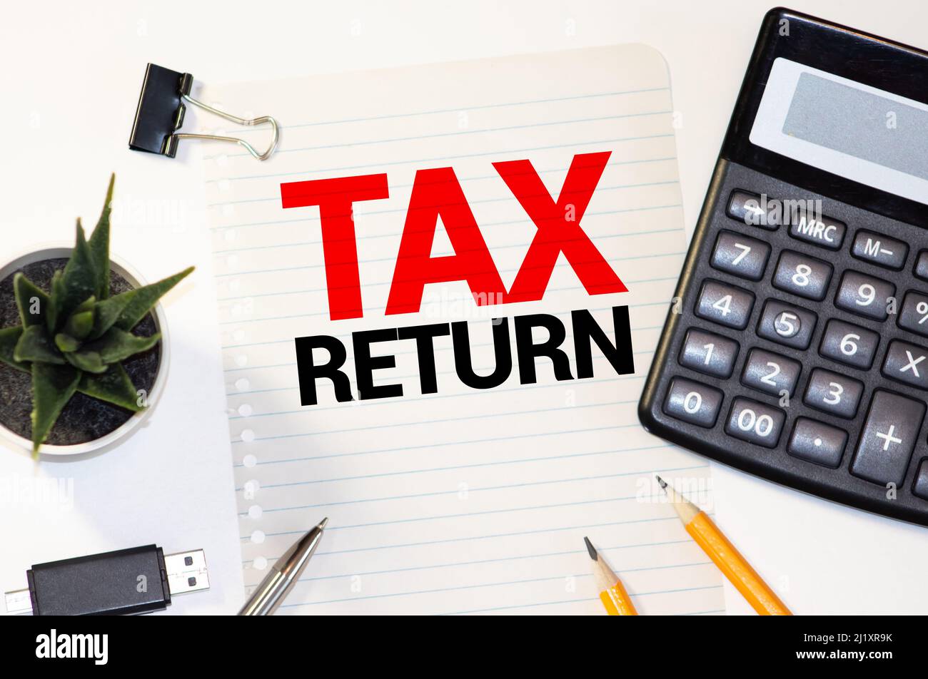 TAX return text on paper. Word TAX return on a piece of paper. Concept ...