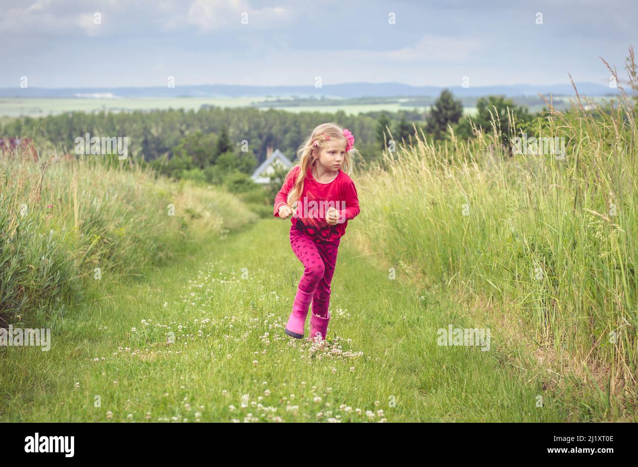 girls running in green rural path among meadows Stock Photo - Alamy